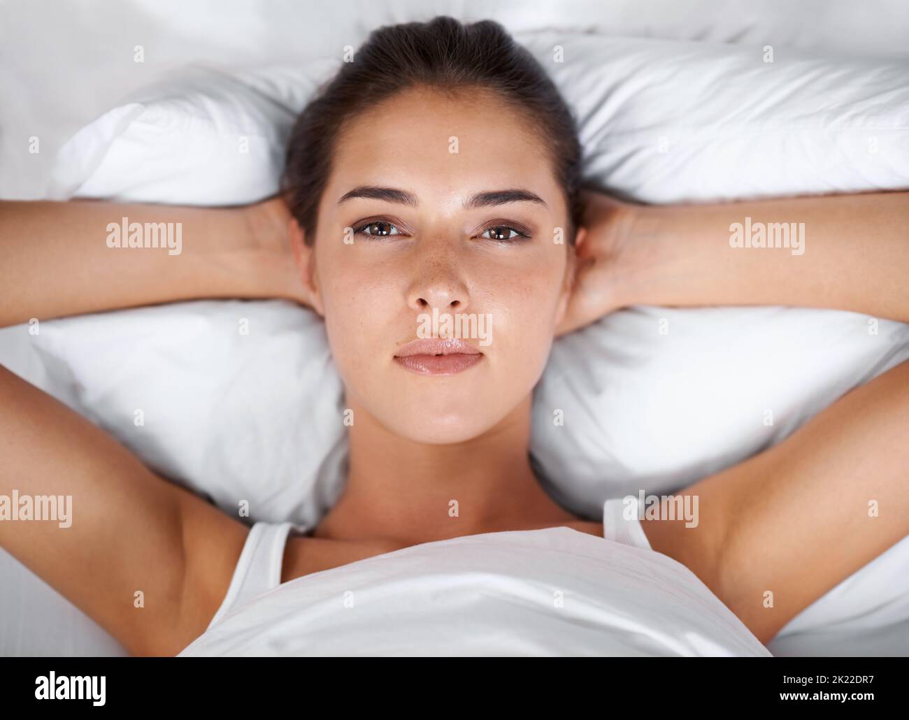 Need motivation to get out of bed today. Portrait of a beautiful young ...