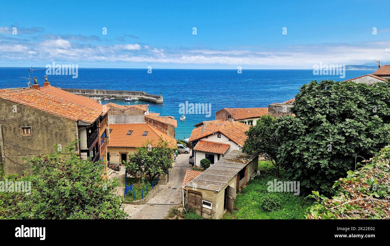 A high angle shot of rural houses and greenery against a blue sea Stock ...