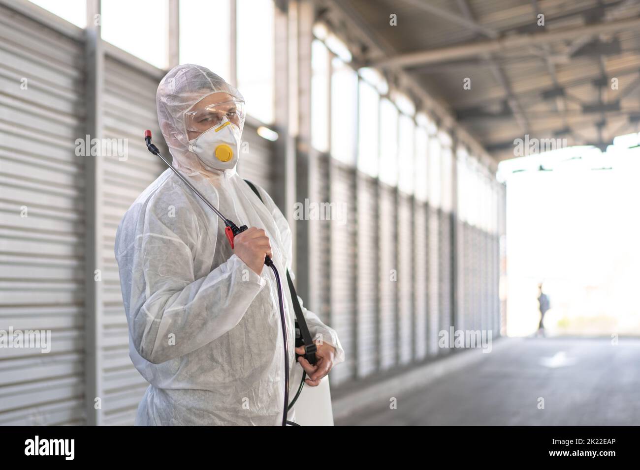 Worker wearing protective suit disinfection gear disinfect surface ...