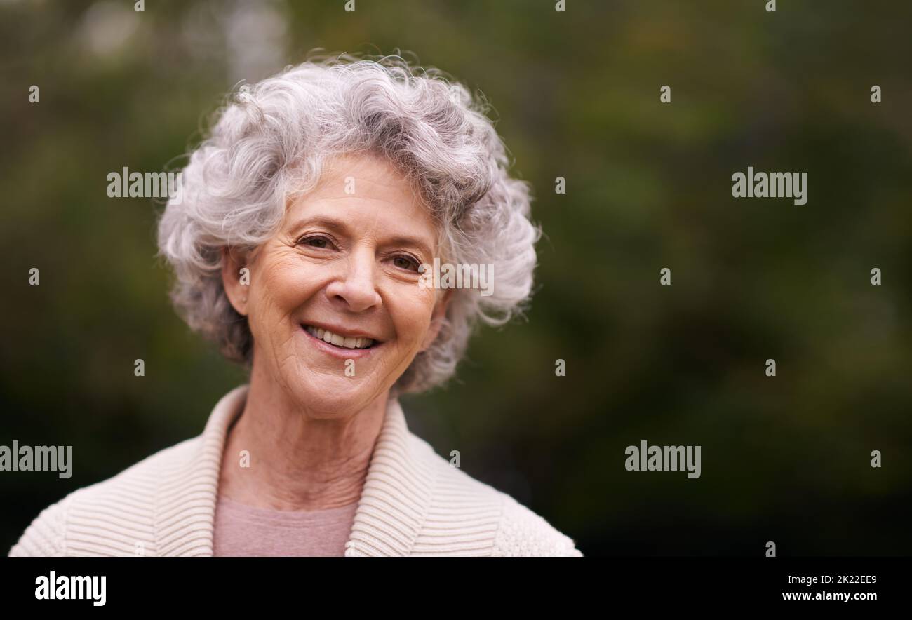 Living life with a smile. Portrait of a smiling senior woman standing ...