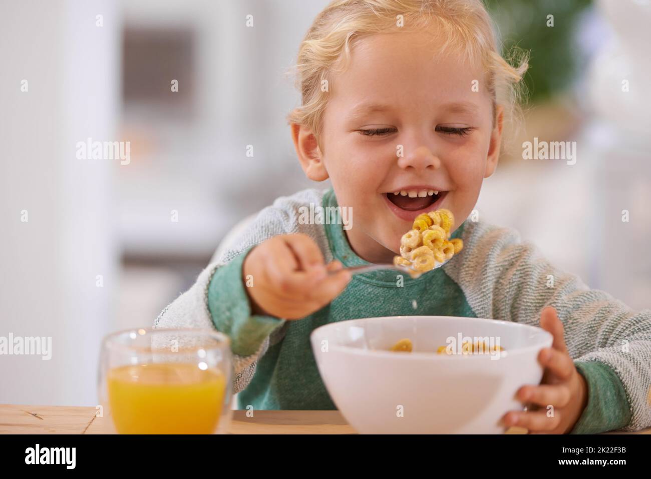 Breakfast time. a cute little girl eating breakfast at home Stock Photo ...