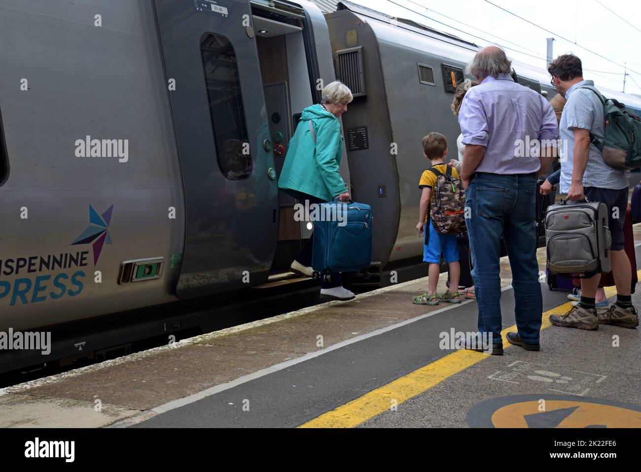 Passengers getting on and off a Trans Pennine Express Class 397 Nova 2 ...