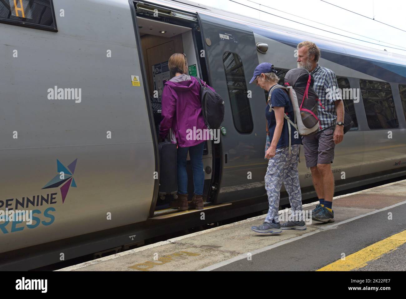 Passengers getting on and off a Trans Pennine Express Class 397 Nova 2 ...