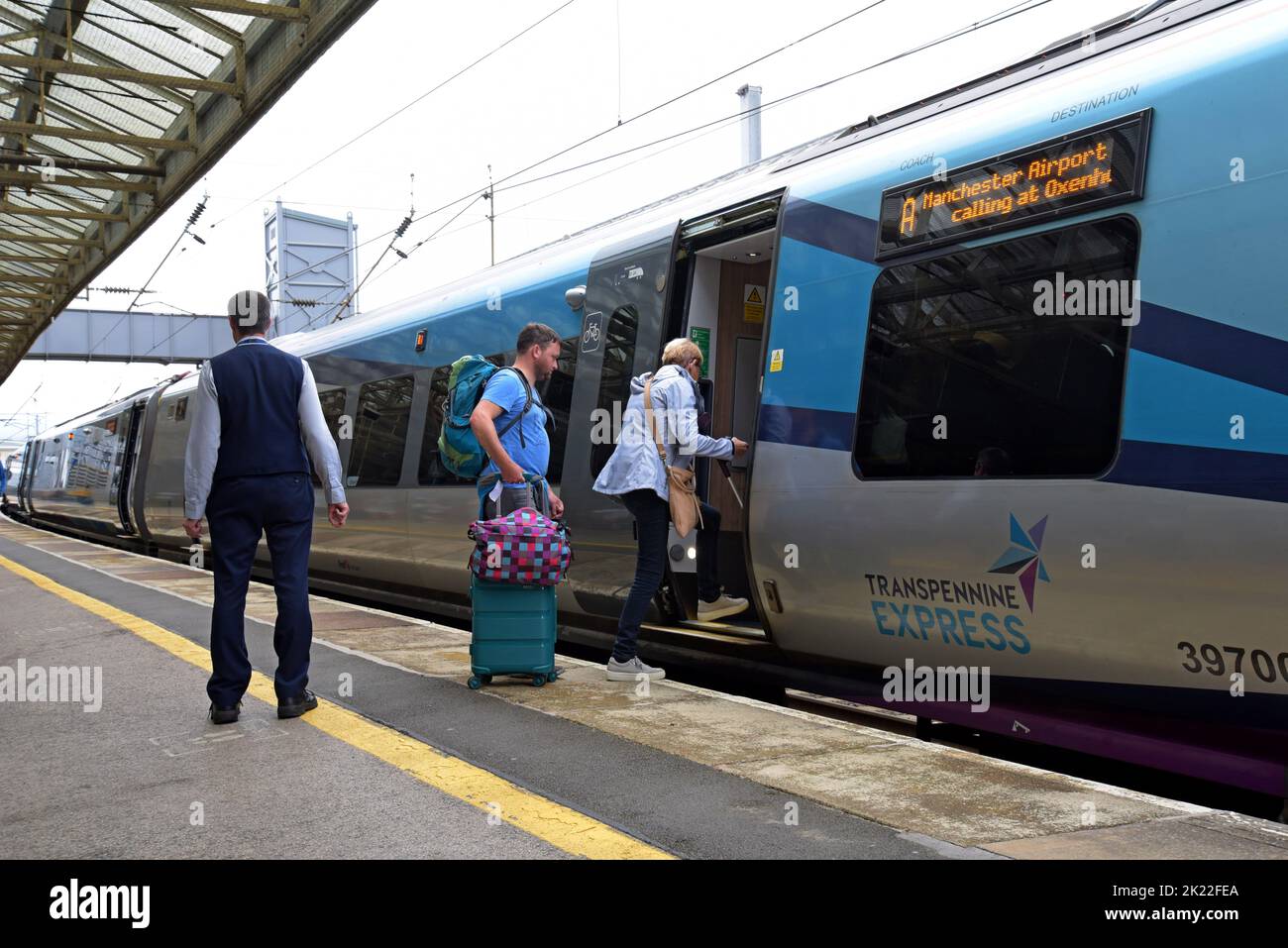 Passengers getting on and off a Trans Pennine Express Class 397 Nova 2 ...