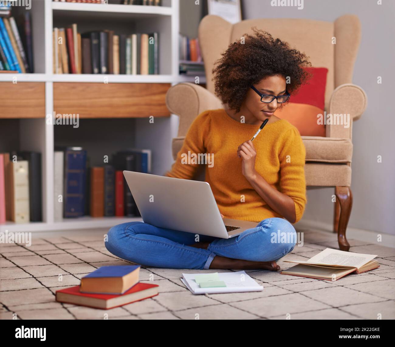 Studying diligently. Full length shot of an attractive young student ...