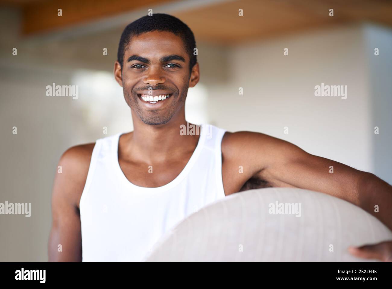 Now for that full body workout. Portrait of a smiling young man holding ...