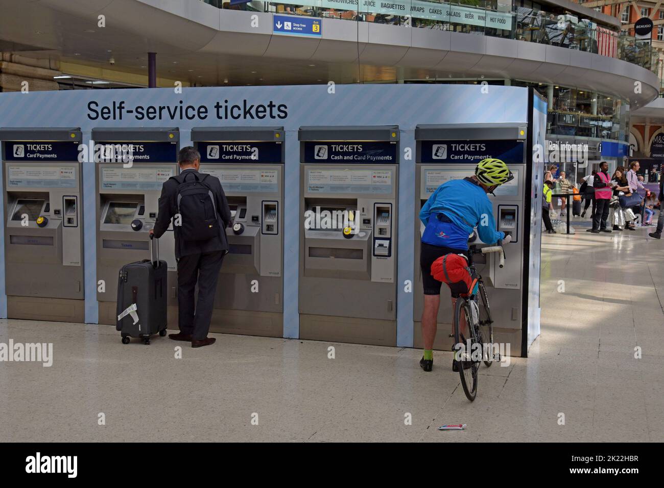 Passengers buying tickets at concourse ticket machines, Waterloo ...