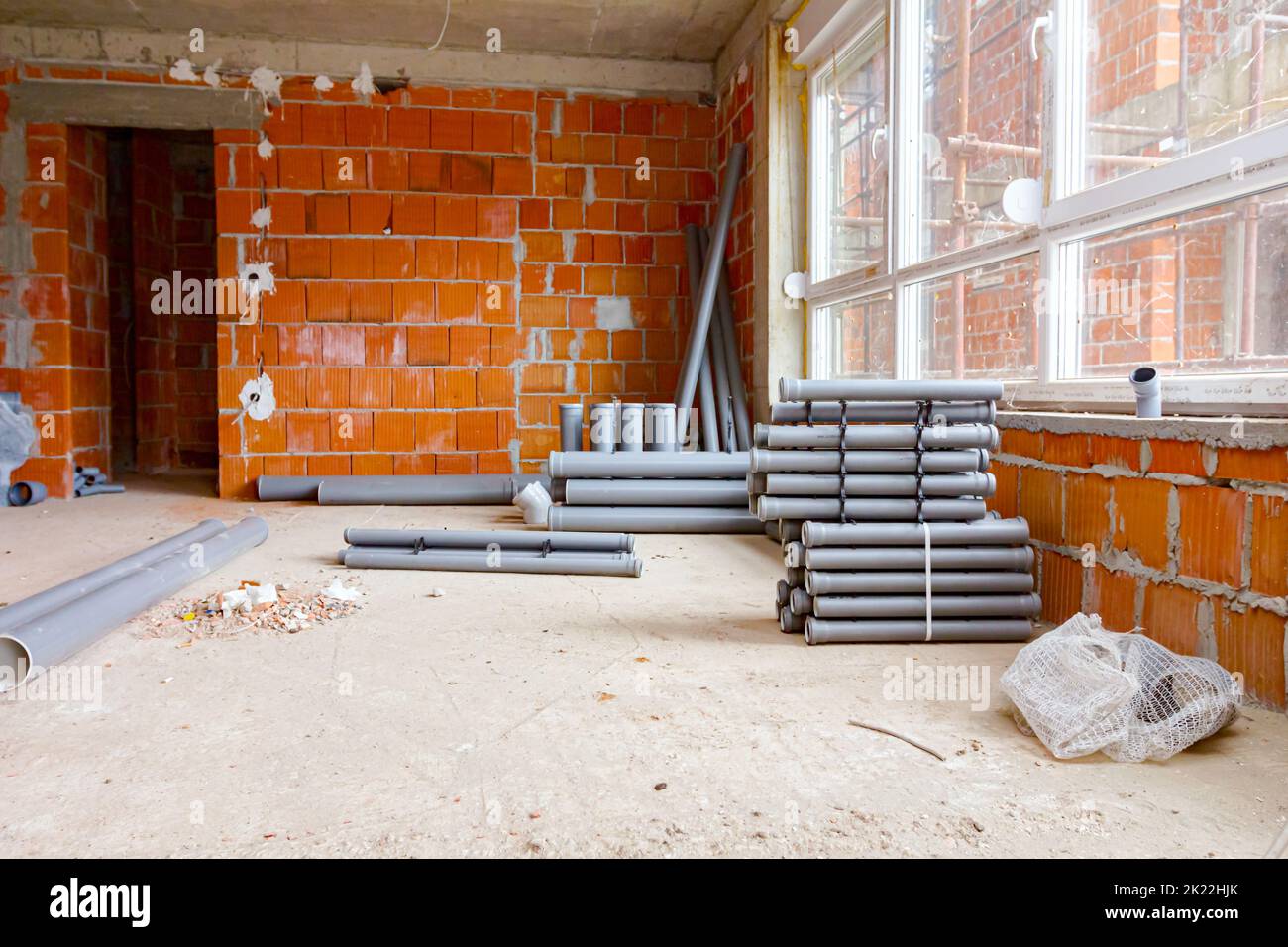 Arranged new grey plumbing sewer pipes are laid down on the floor ...