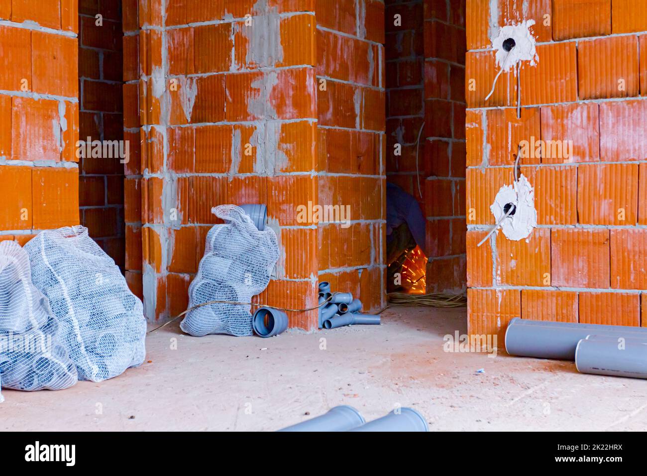 Stack of arranged parts of new grey plumbing sewer pipes elbows placed ...