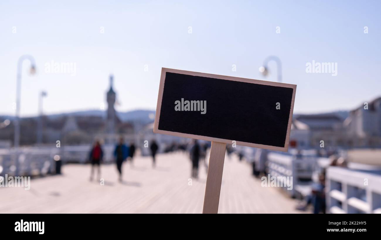 Blank Black billboard against Crowds of tourists The Sopot Pier in the ...