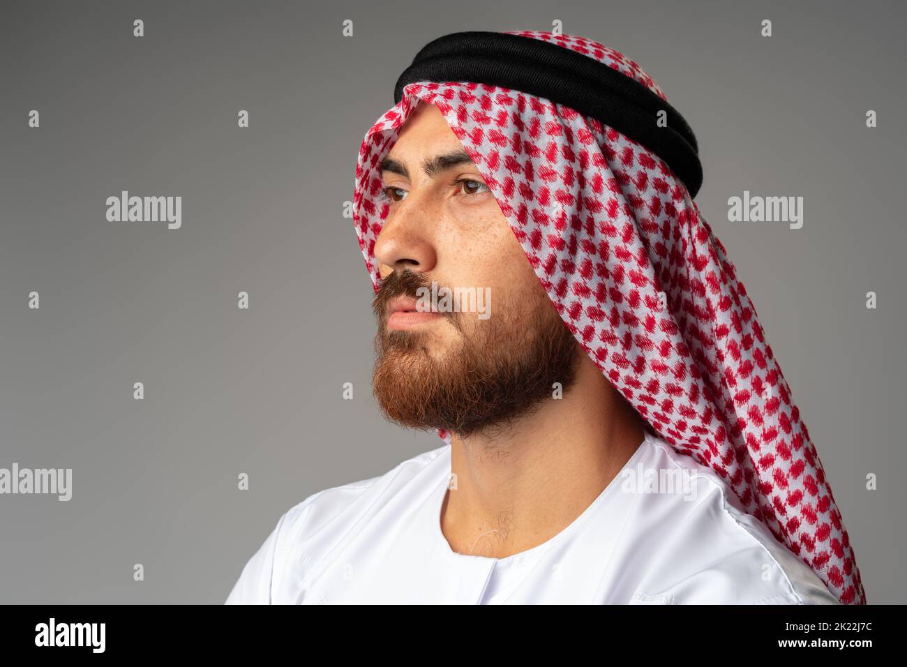 Portrait of young Arab man on gray background in studio Stock Photo - Alamy