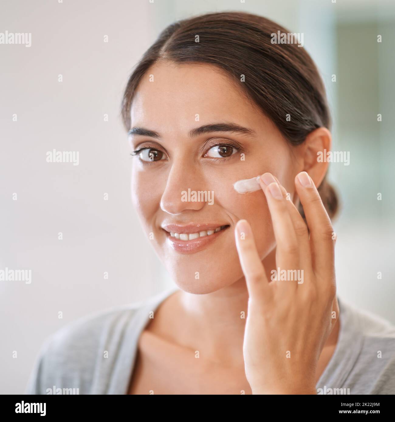 Keeping Her Skin In Perfect Condition A Beautiful Woman Applying