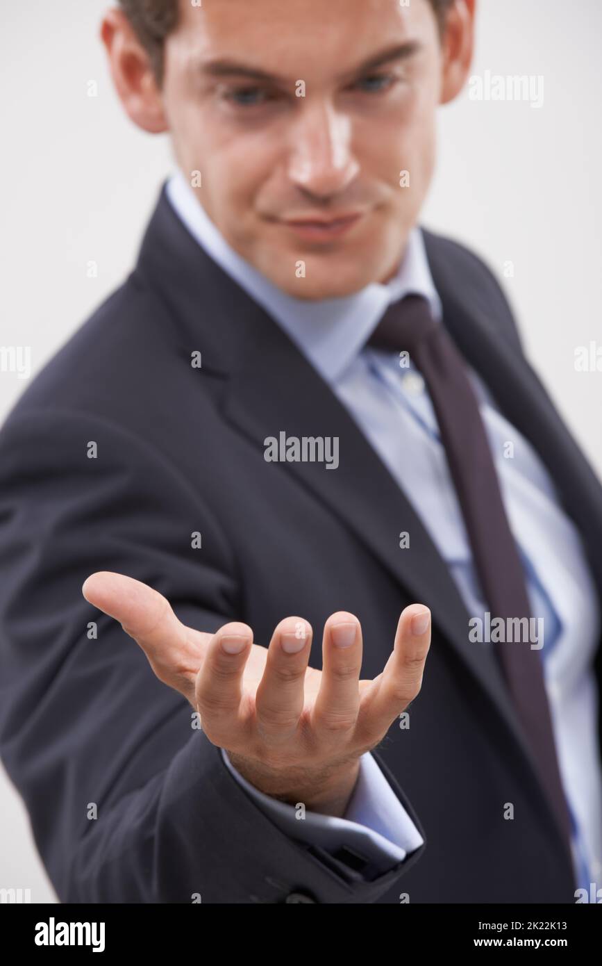 The future is within his grasp. a handsome young businessman holding ...