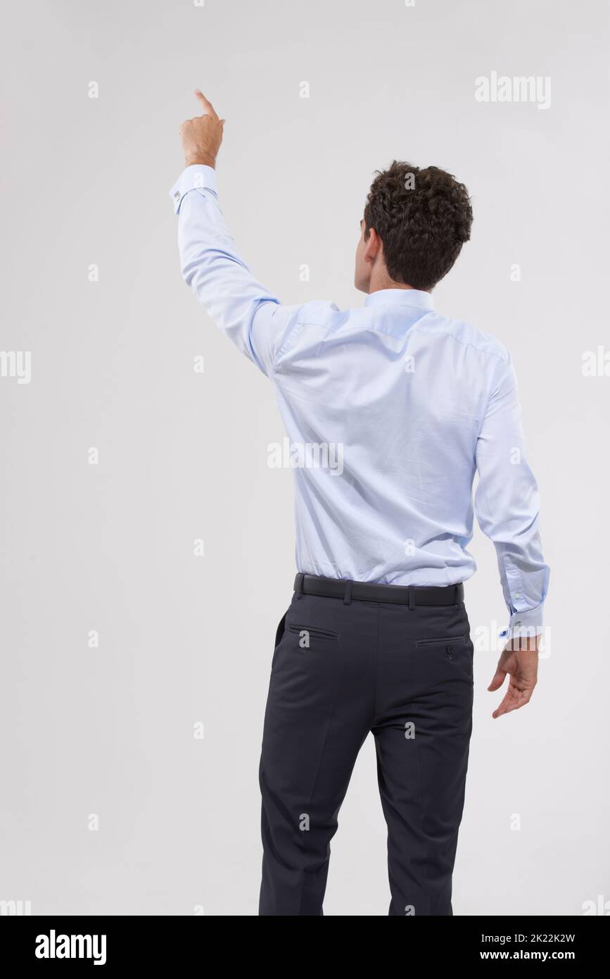 The future is just a touch away. Rear view of a handsome young ...