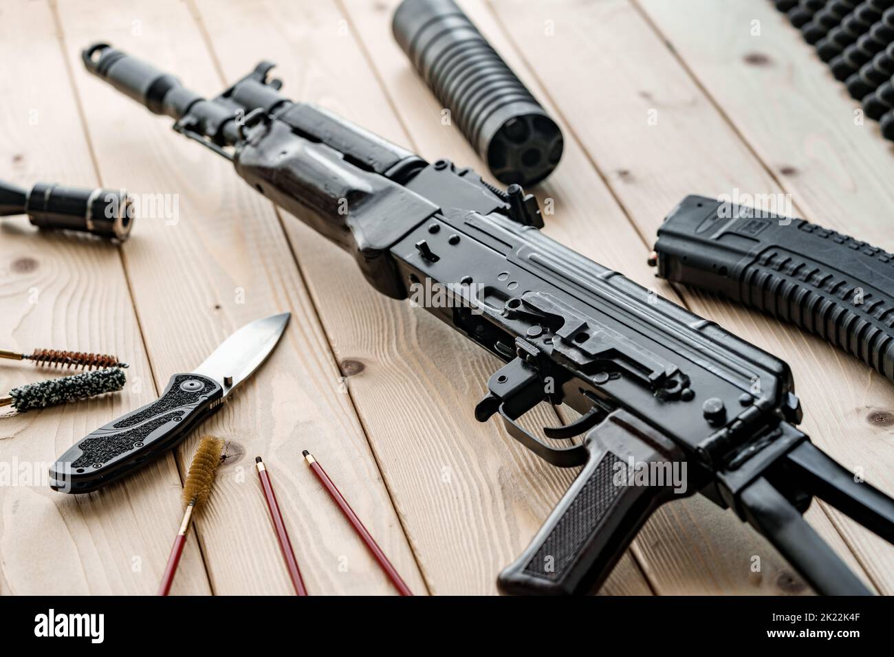 Disassembled rifle with cleaning tools on table of weapons workshop ...