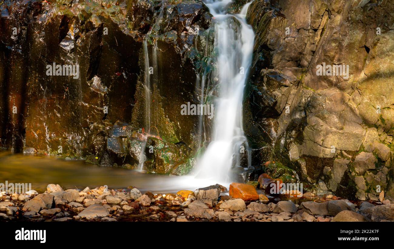 A large splashing cascading waterfall in the mountains Stock Photo - Alamy