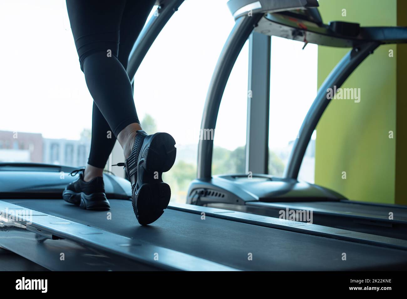 Photo of legs of woman in black comfortable sneakers and leggings ...