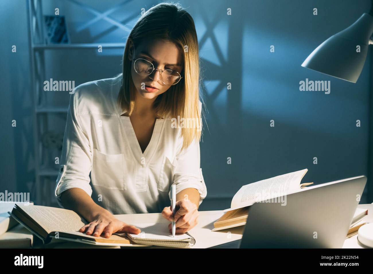 Night study. Online learning. Distance education. Remote class. Student woman working from home ...