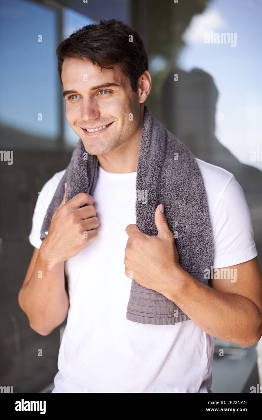 Ready and refreshed for a new day. a cheerful man standing with a towel ...