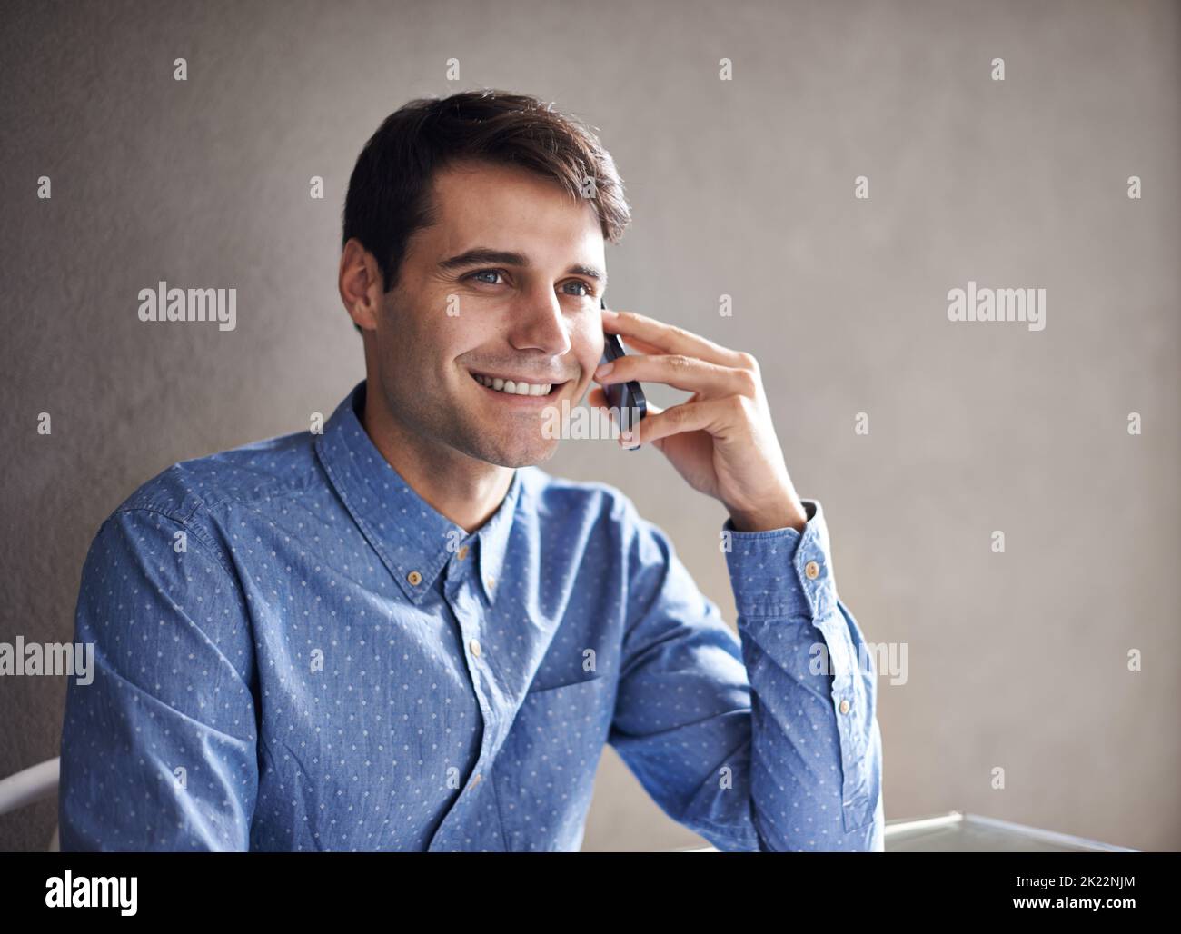 Every client is important to him. a confident young businessman talking ...