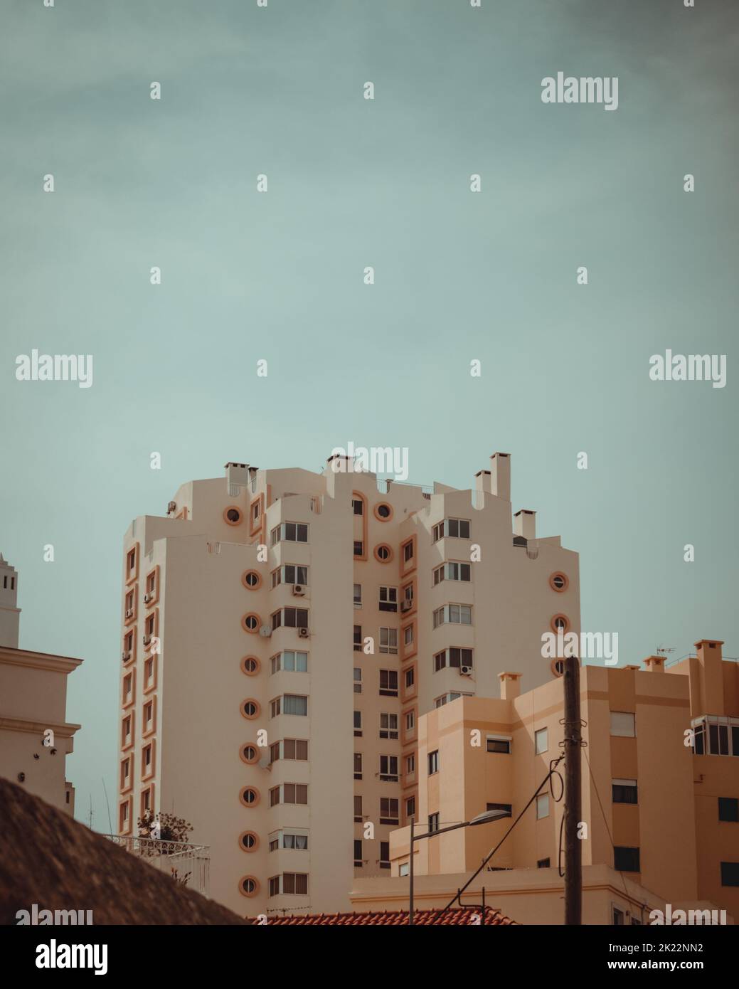 A tall apartment building in the center of Lagos, Portugal on blue sky ...