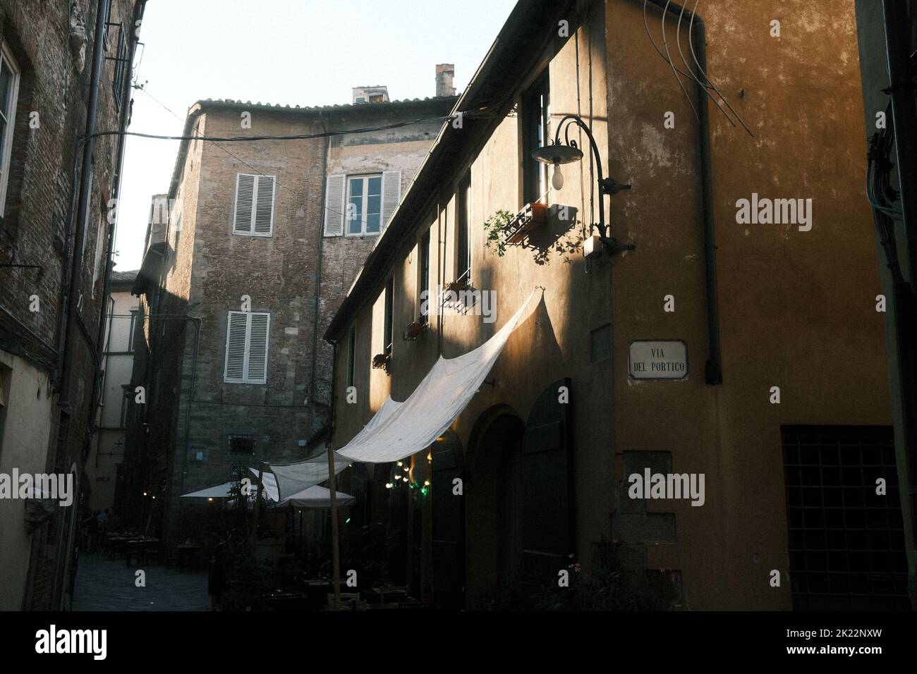 A Low-angle shot of traditional Italian houses facing the courtyard ...