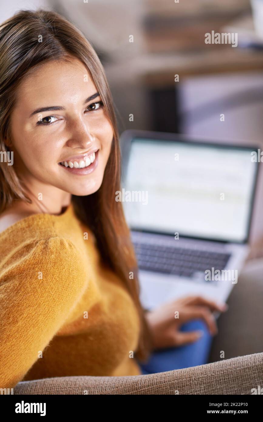 Ready for a weekend of relaxation. A young woman on the couch with her ...