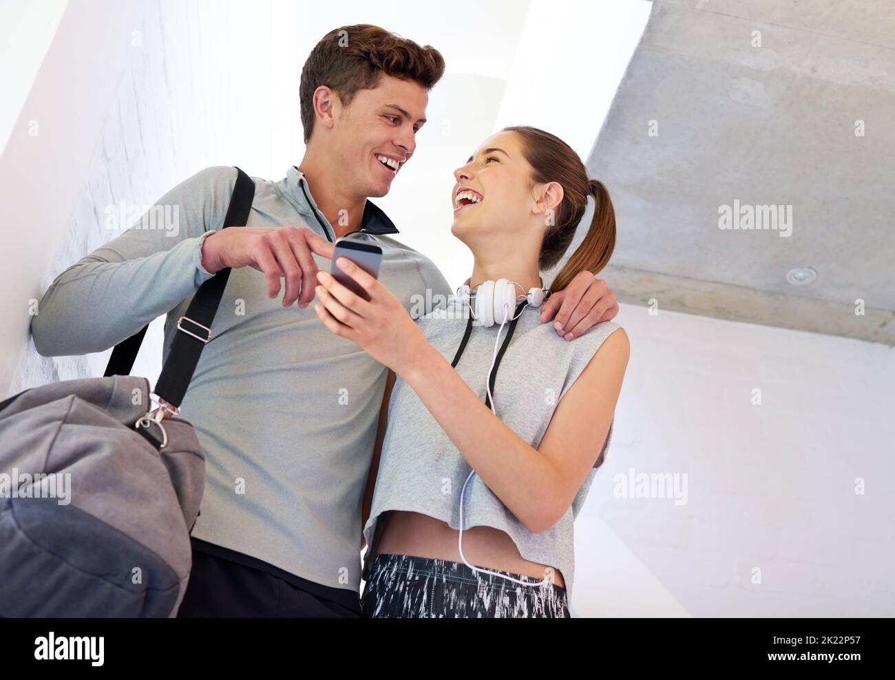 Having a laugh on the way to gym. a sporty young couple laughing ...