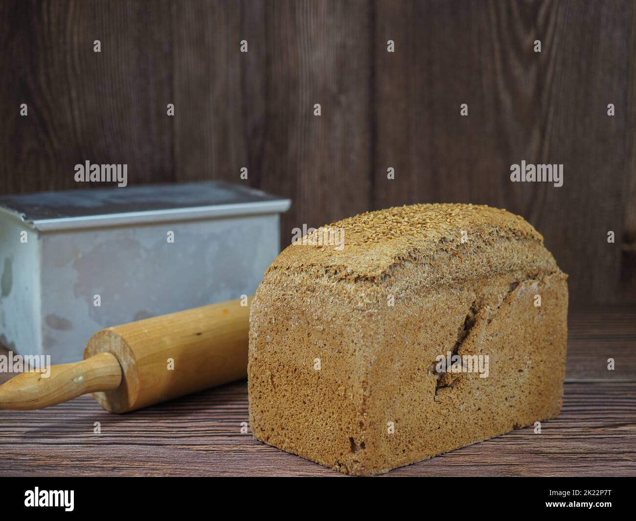 closeup of homemade bread with bakery utensils and wooden background ...