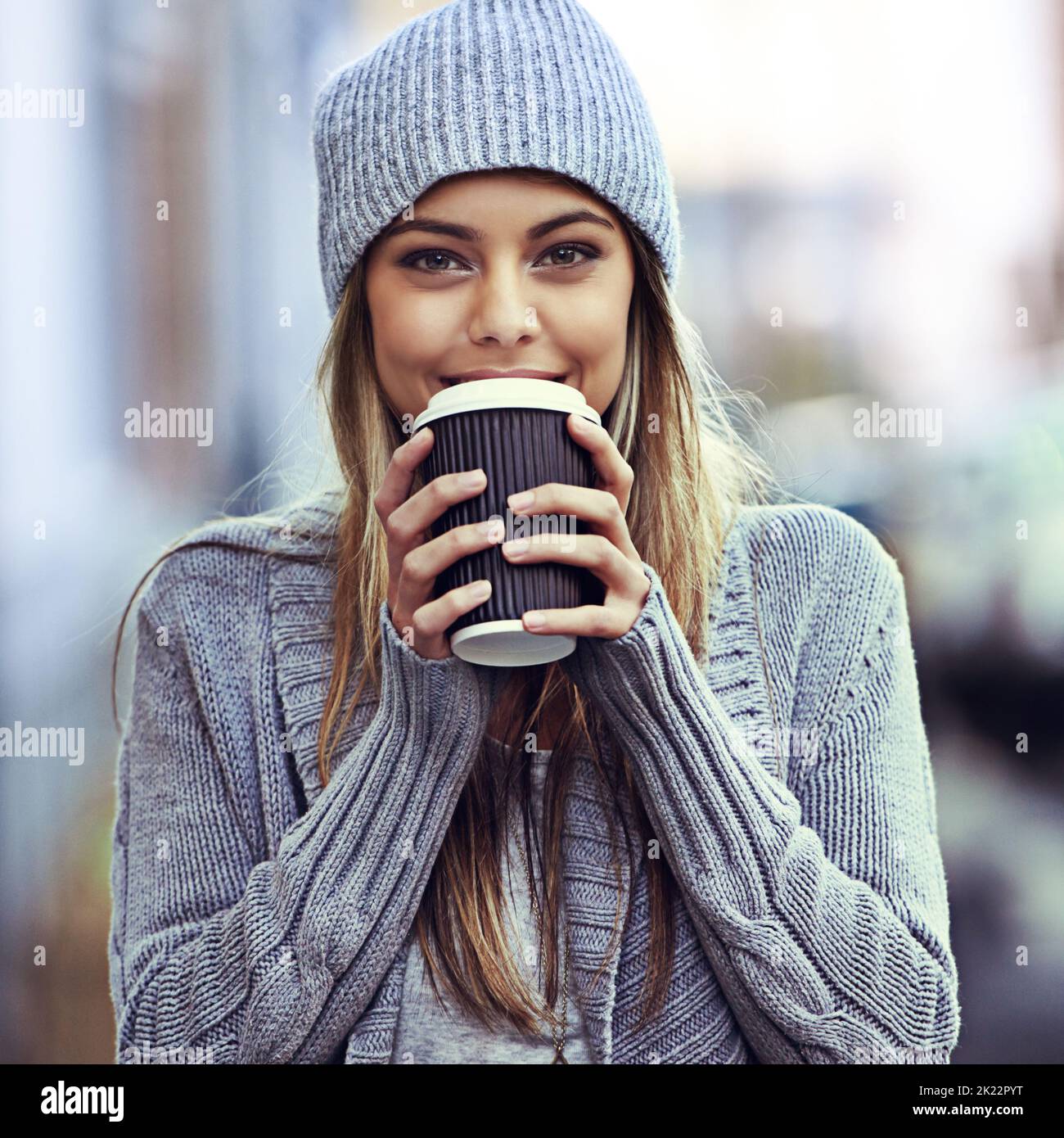 Shes just been to her favorite coffee place. Portrait of a beautful ...
