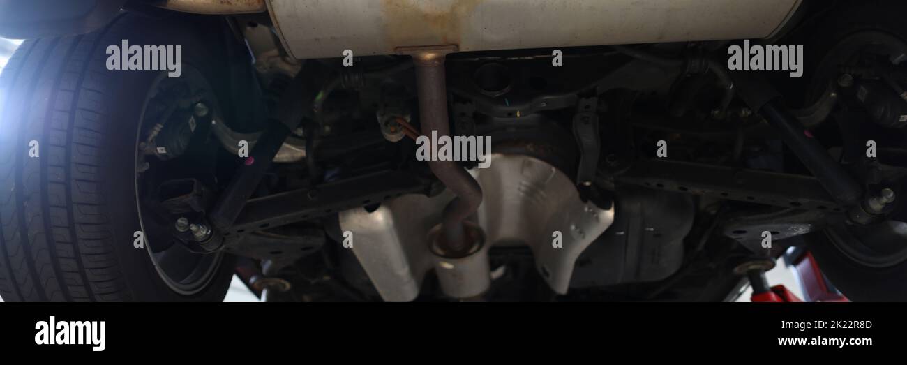 Bottom of car with muffler on lift Stock Photo - Alamy