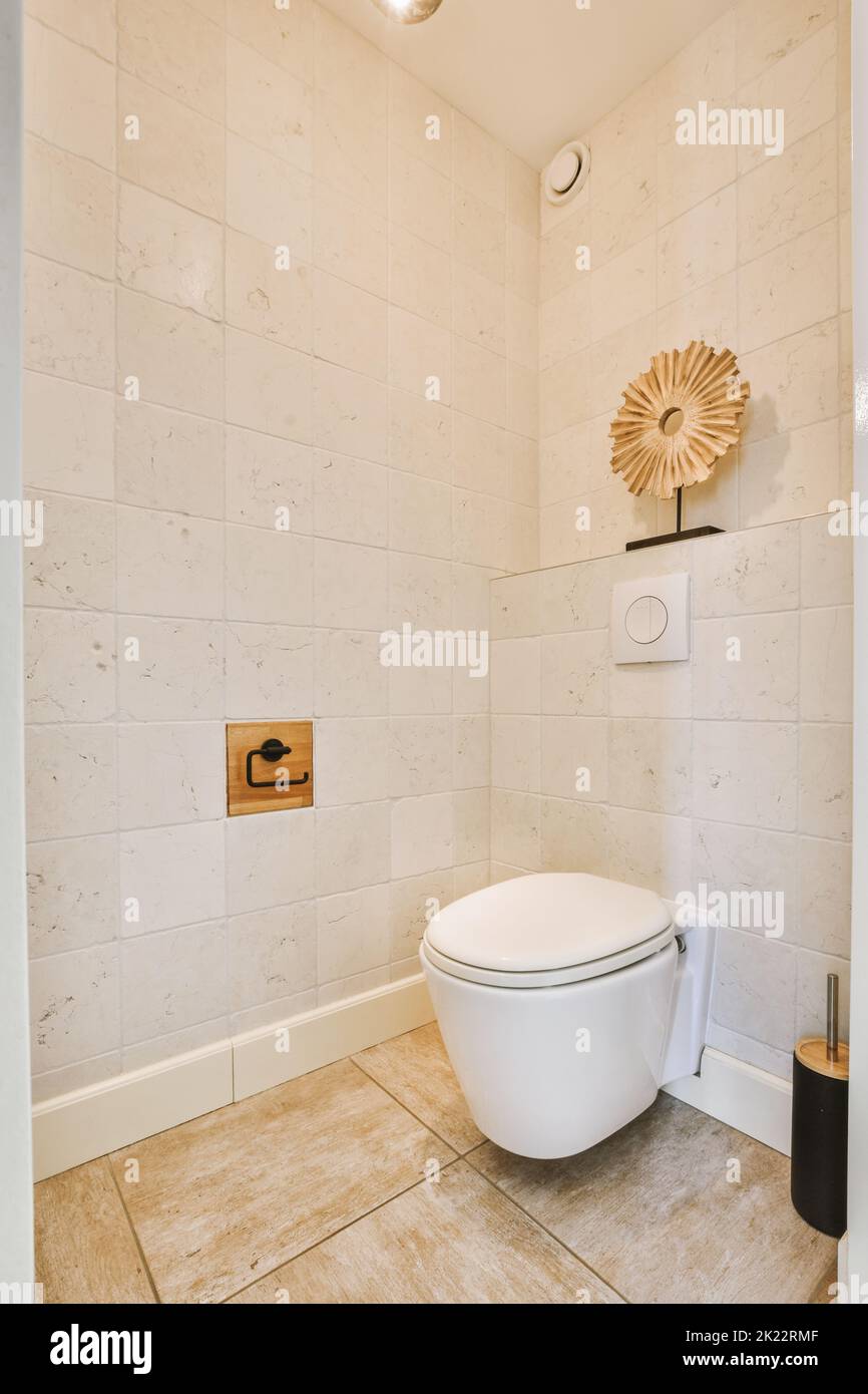 Interior of narrow restroom with wall hung toilet with white walls and ...