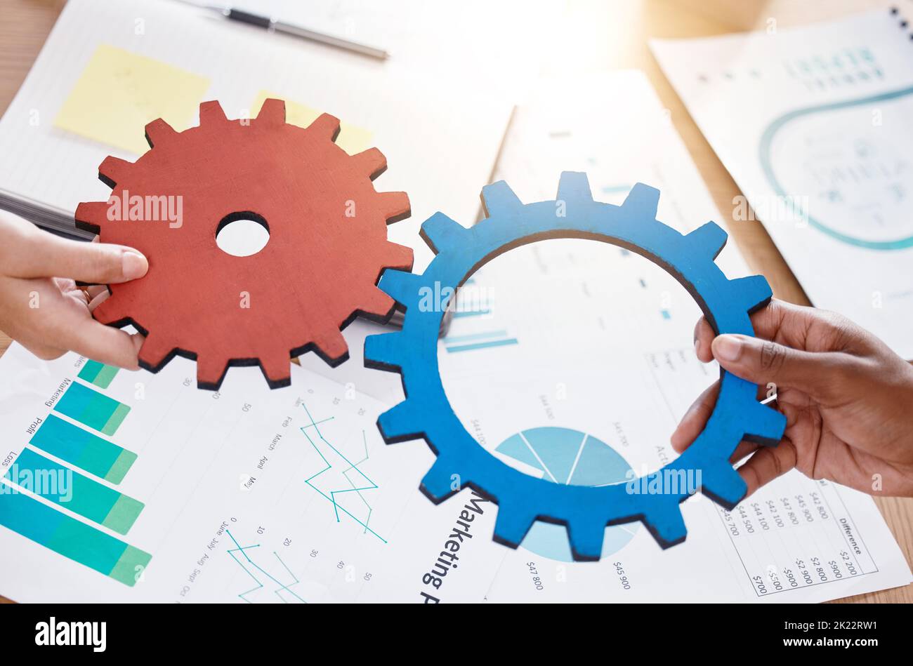 Hand, gear and teamwork with parts in the hands of business people ...