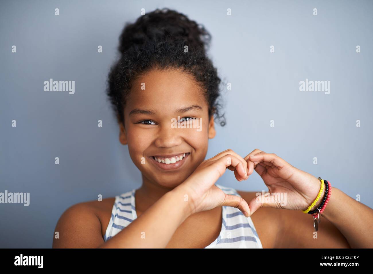 Shes got a big heart. a young girl making a heart with her hands Stock ...