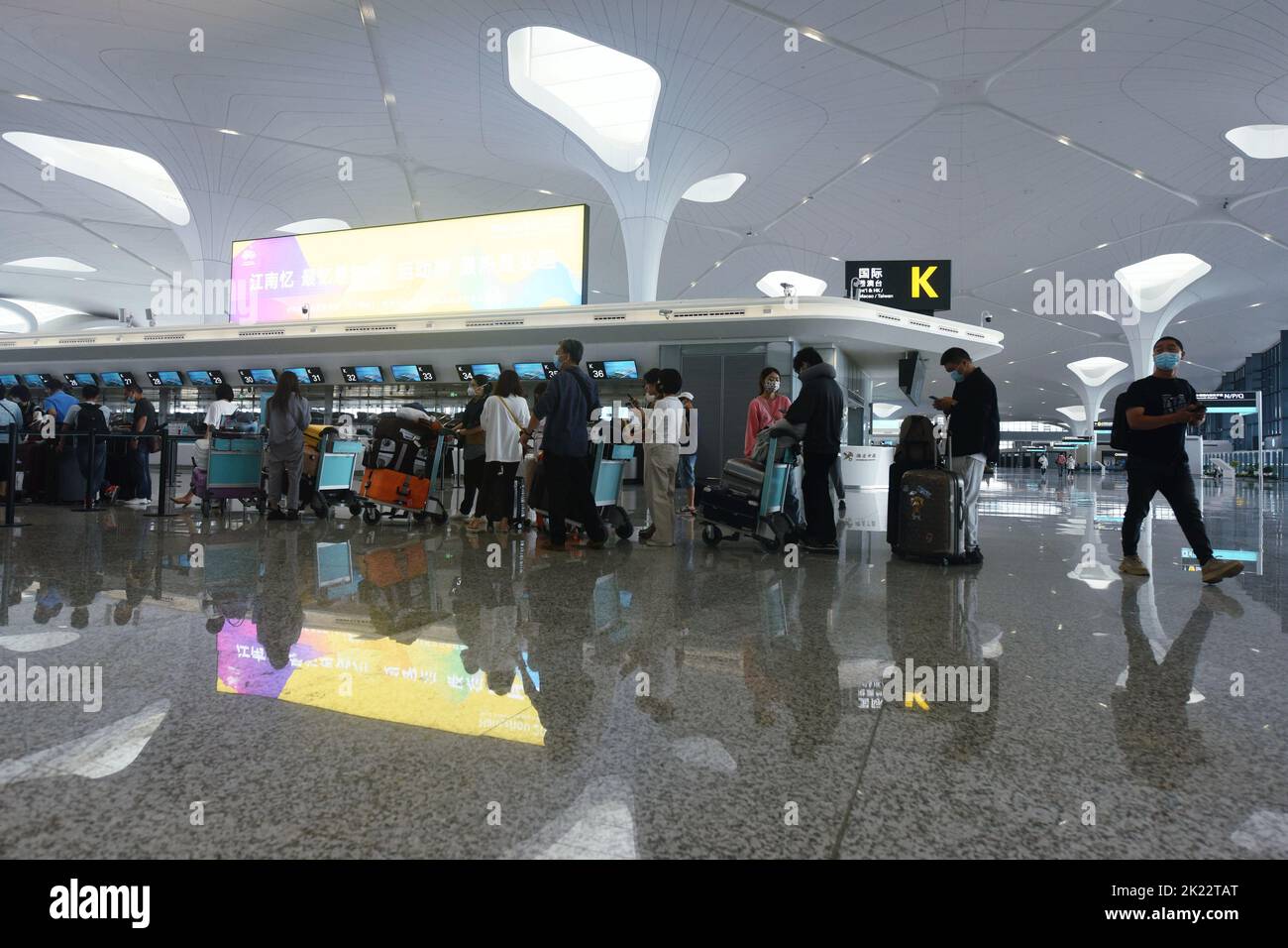 HANGZHOU, CHINA - SEPTEMBER 22, 2022 - Passengers line up to check in ...