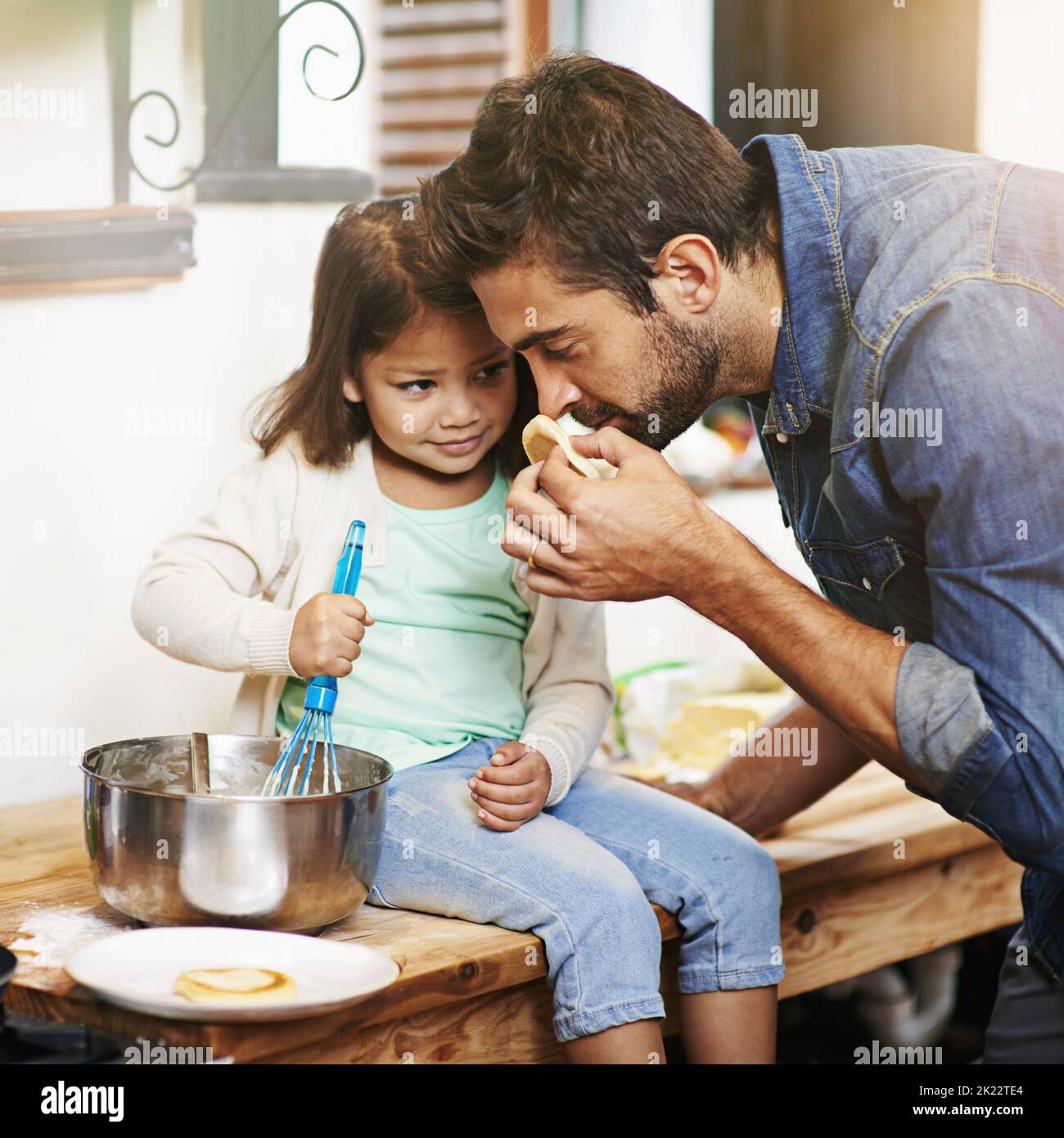 Smells as yummy as it looks. a father and daughter making pancakes ...