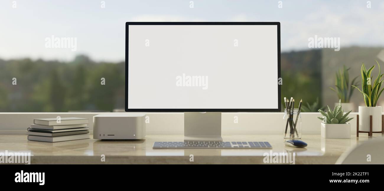 Close-up, Modern PC desktop computer white screen mockup, keyboard, mouse, stack of books, and ...