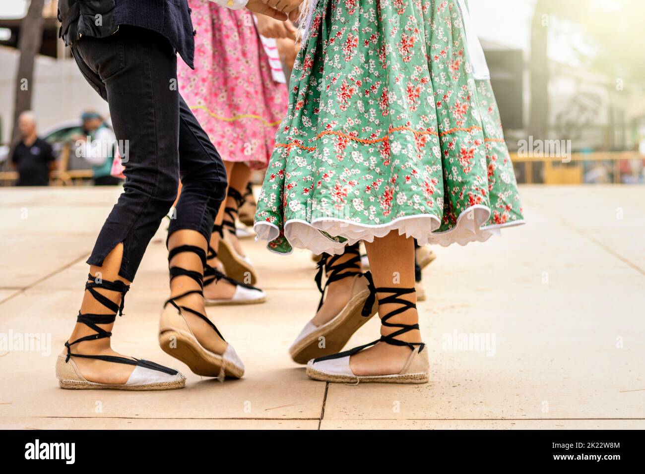 Spanish folk dance. Young boys and girls dancing in period costumes ...