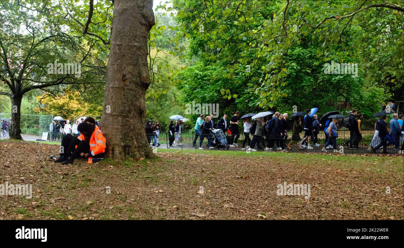 Two crowd control marshals taking a break on a tree whilst the crowds ...