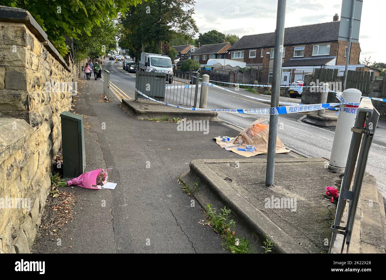 Police cordon and a floral tribute near to the scene in Woodhouse Hill ...