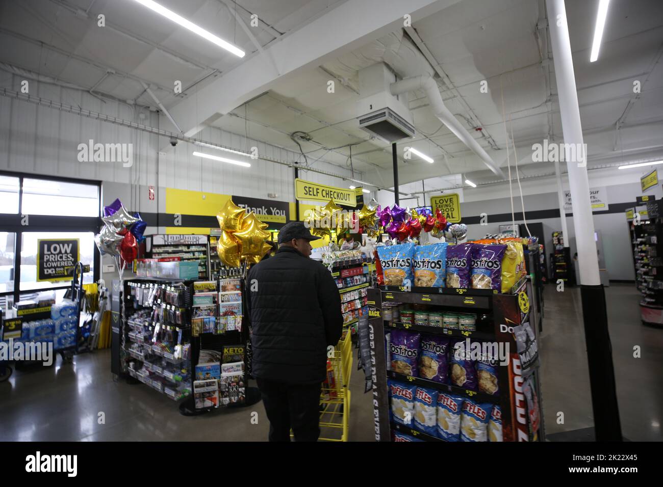 A customer heads to the checkout in a Dollar General store Stock Photo ...