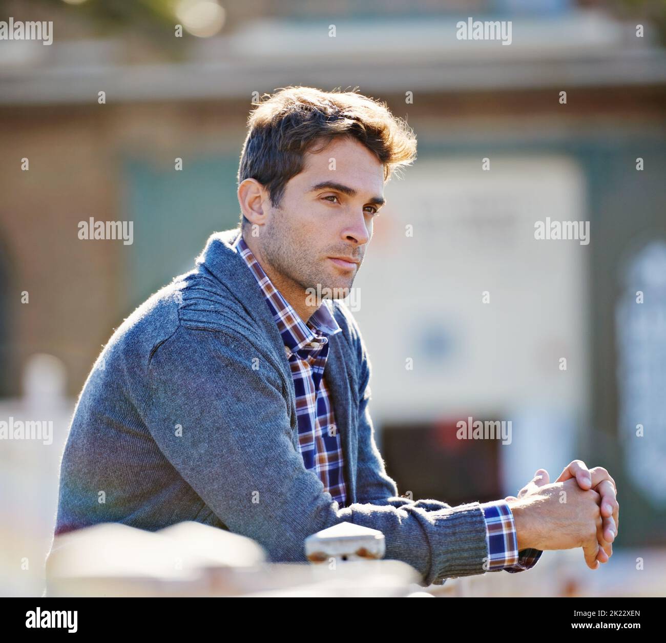 What does it all mean. a handsome young man leaning over a railing ...