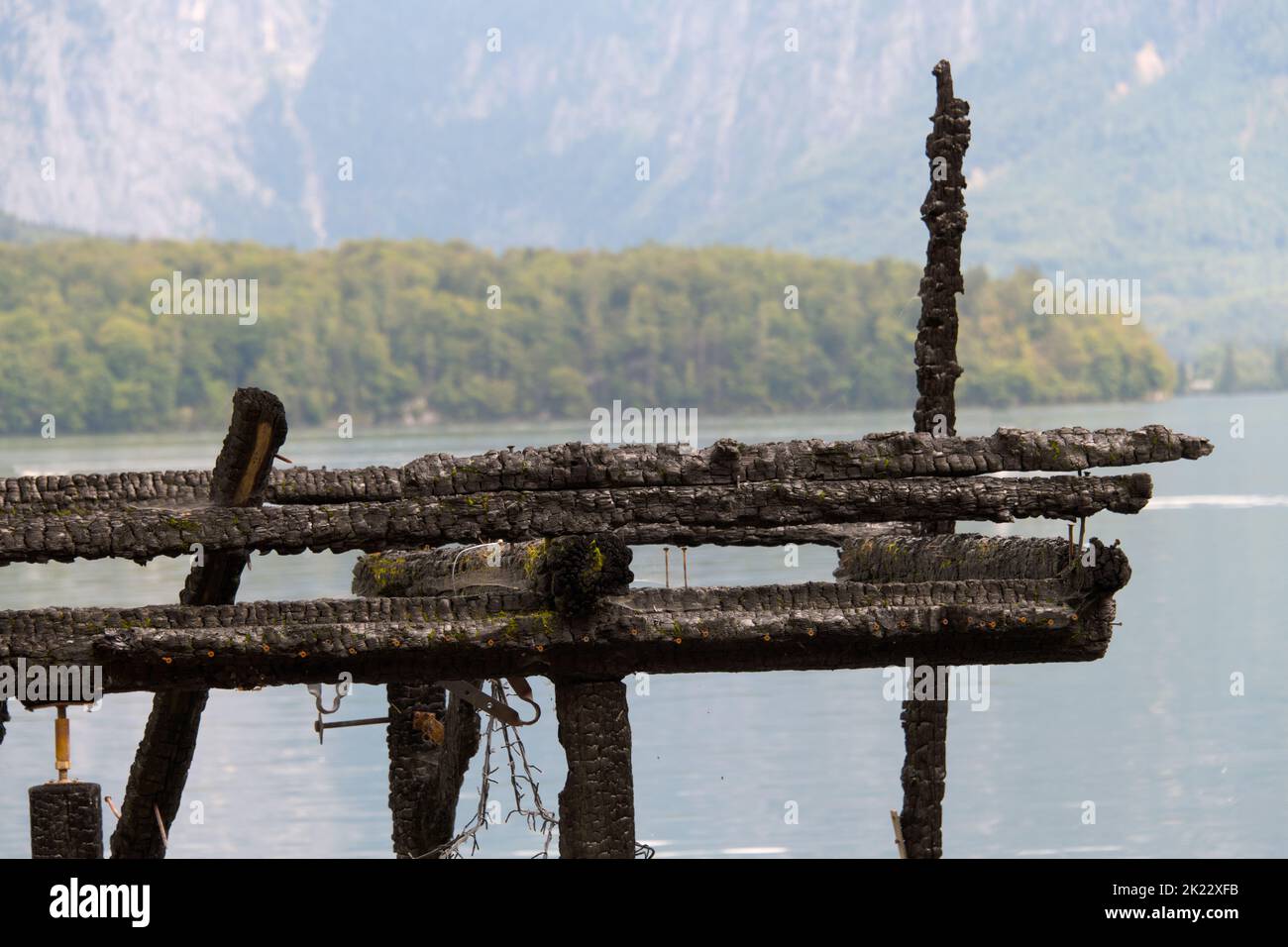 Close up of burnt charred wooden wood structure on a lake as a concept ...