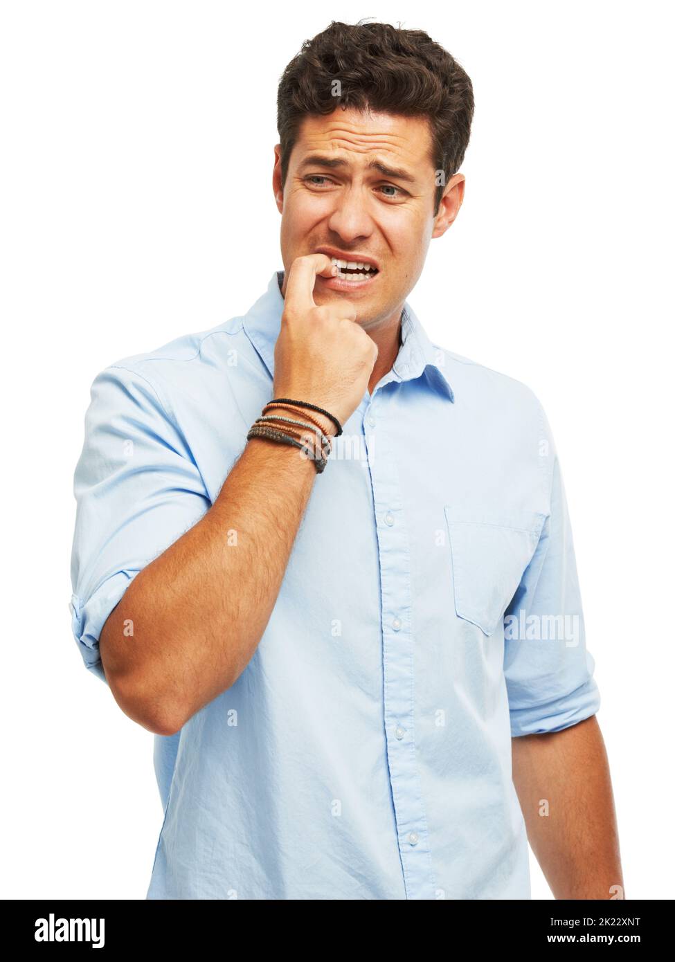 Uncertainty - A nail bitting experience. A handsome young man biting ...