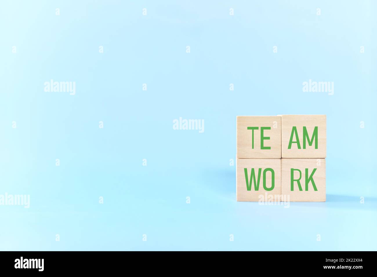 Teamwork and team building business concept. Hand putting together wooden blocks wood puzzle ...