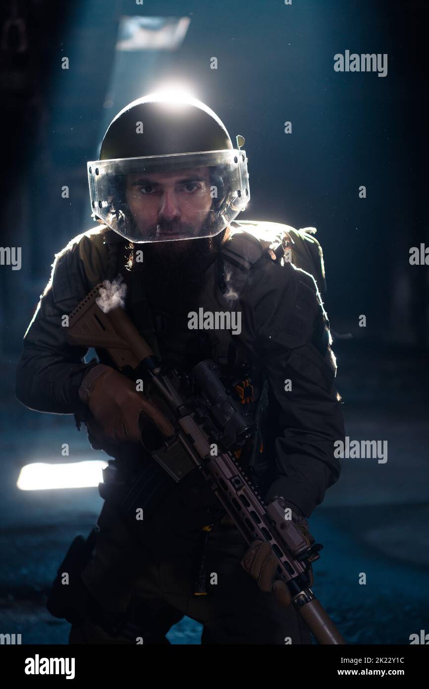 Army soldier in Combat Uniforms with an assault rifle and combat helmet ...