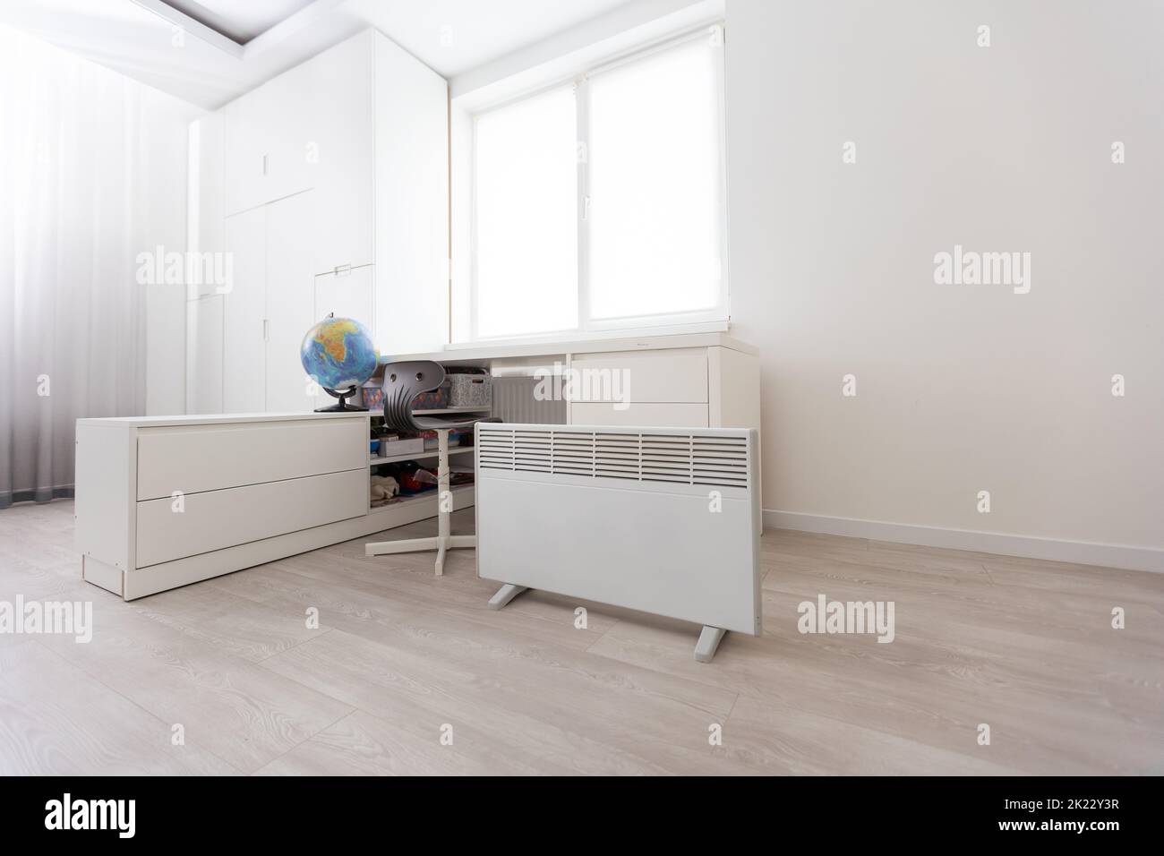 Modern electric heater in stylish room interior Stock Photo - Alamy