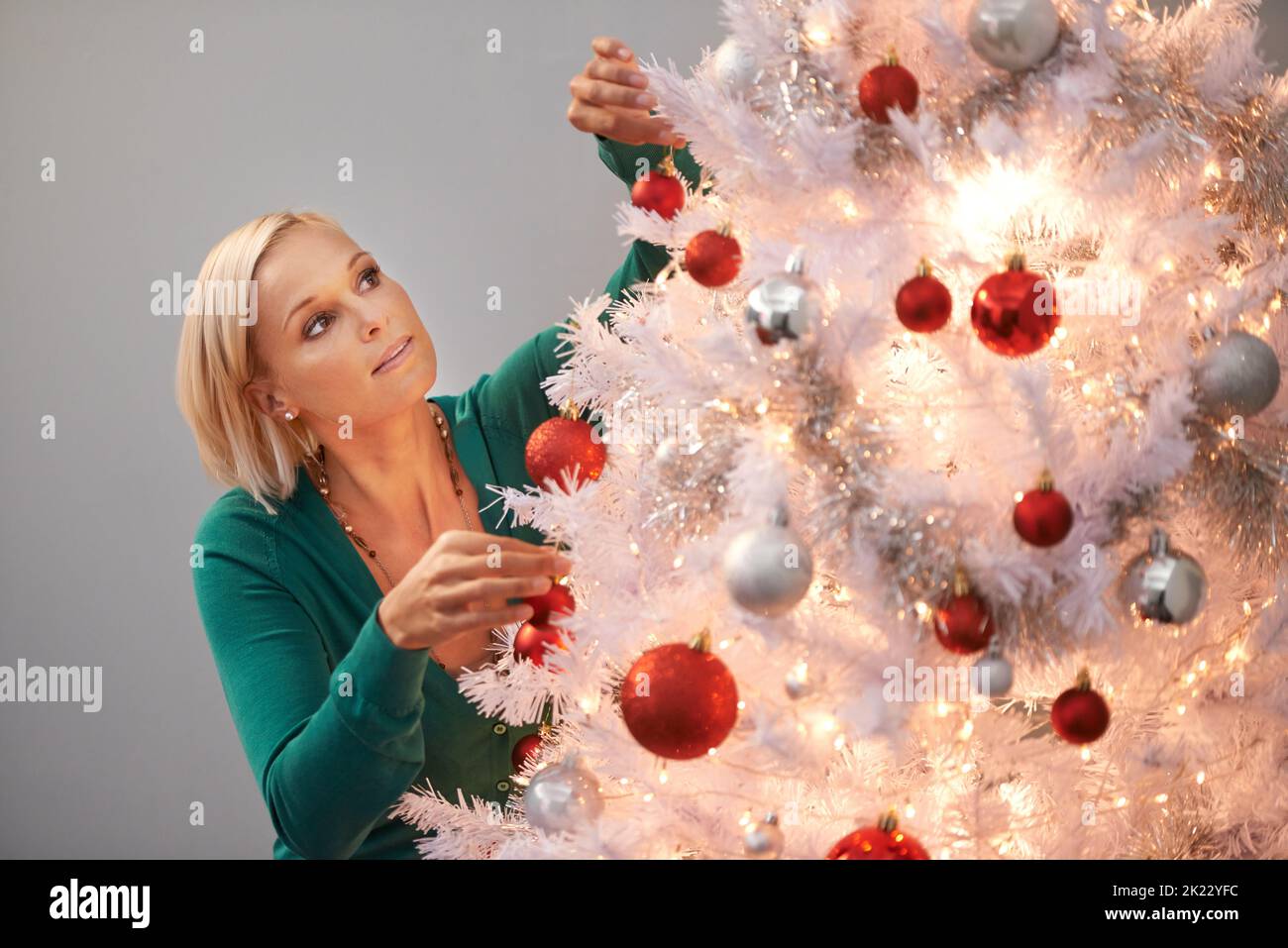 My favourite part of the holidays. a beautiful woman decorating a white ...