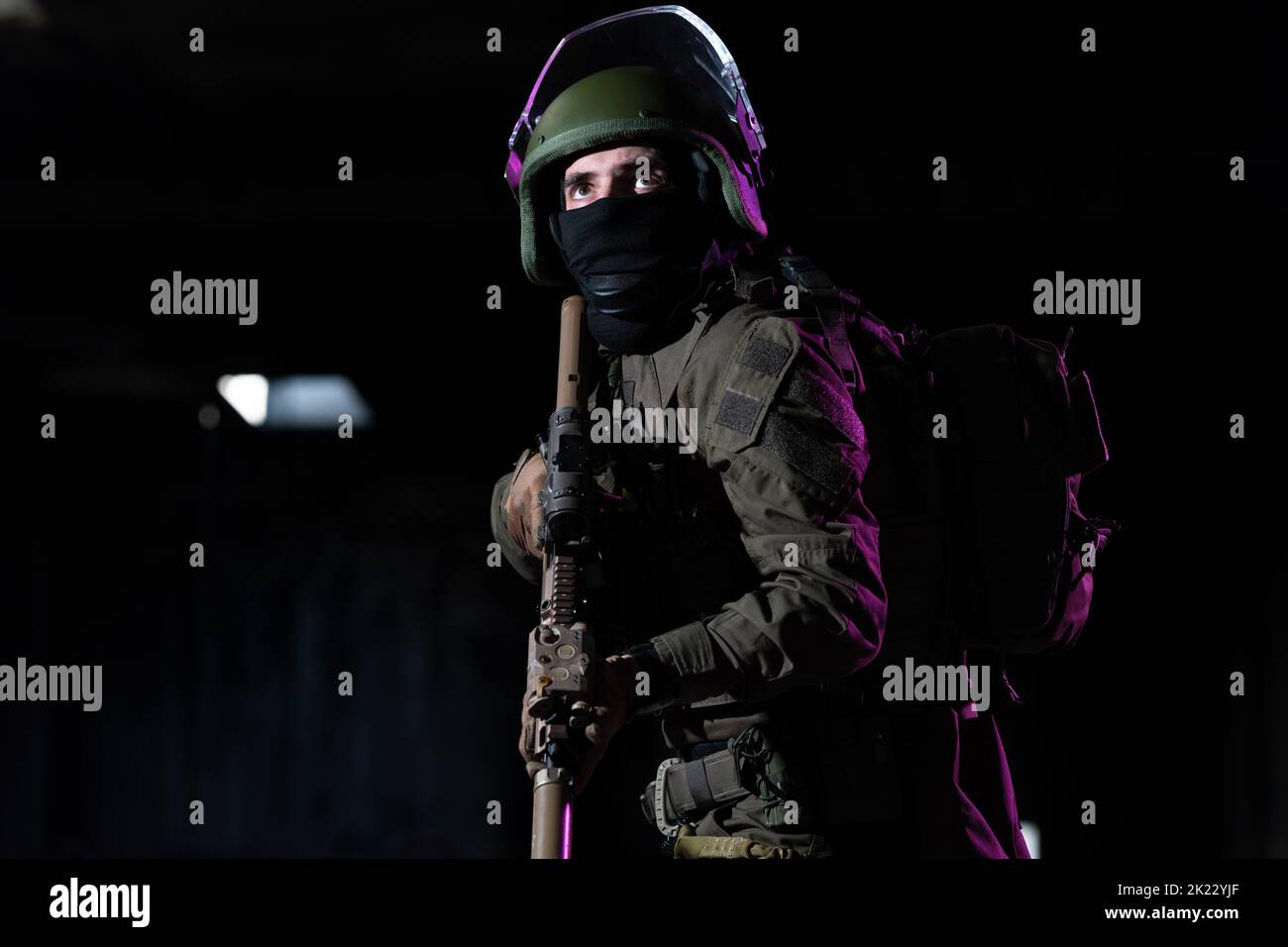 Army soldier in Combat Uniforms with an assault rifle and combat helmet ...