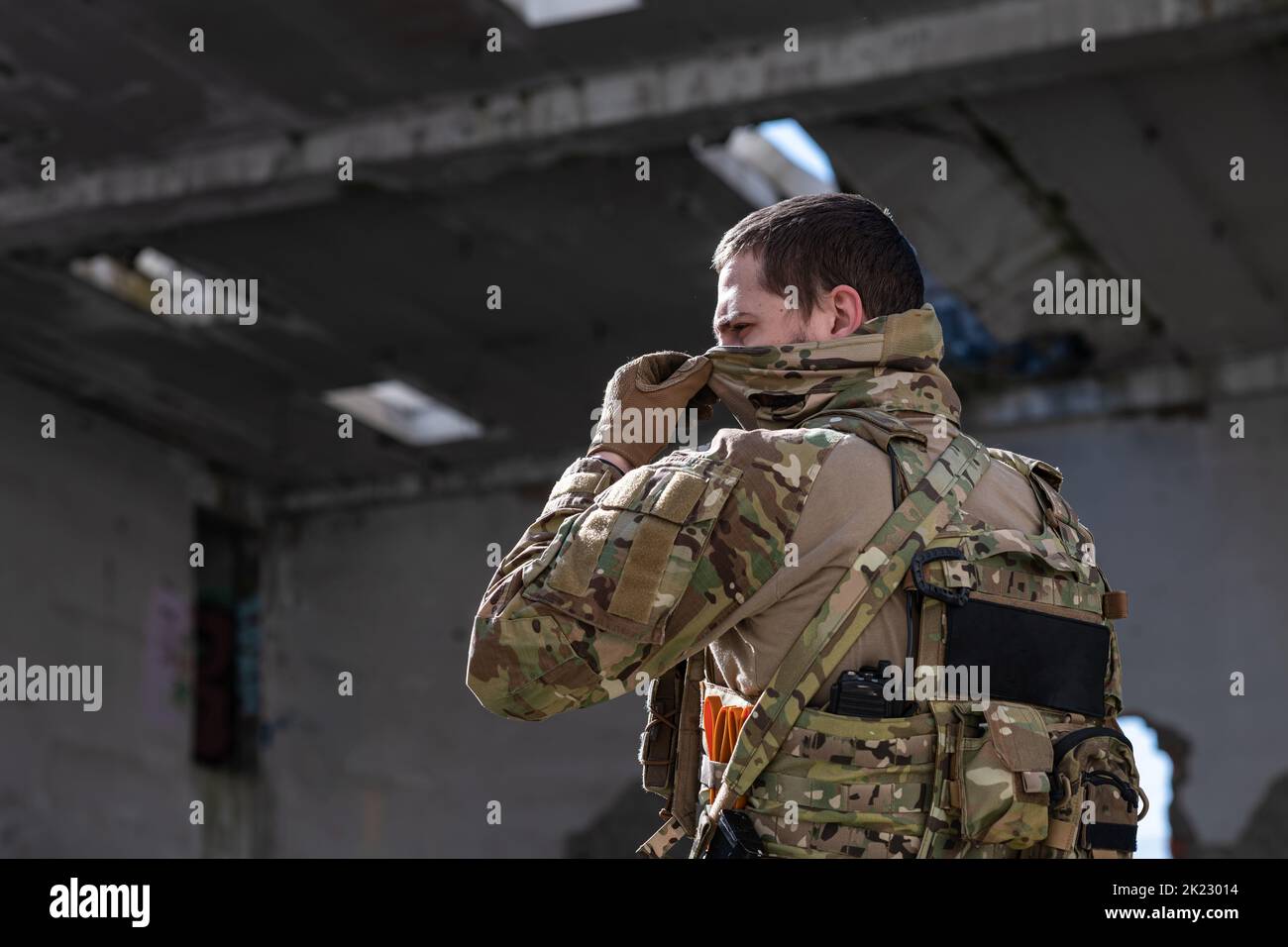 Army soldier in Combat Uniforms with an assault rifle and face ...